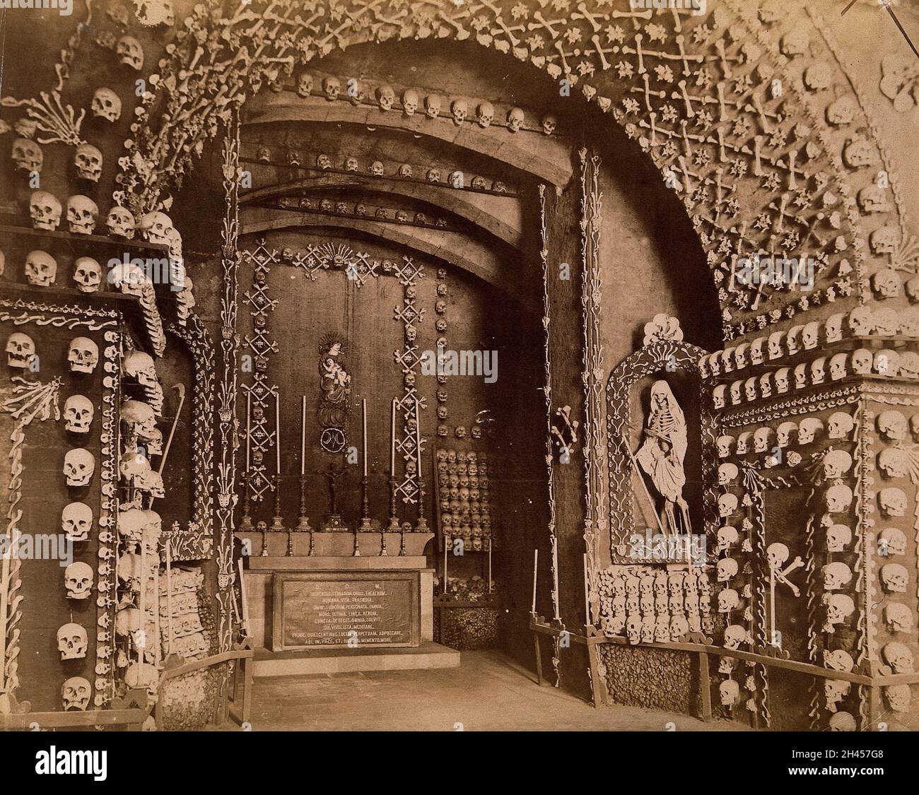 An altar bearing a Latin inscription surrounded by an array of human ...