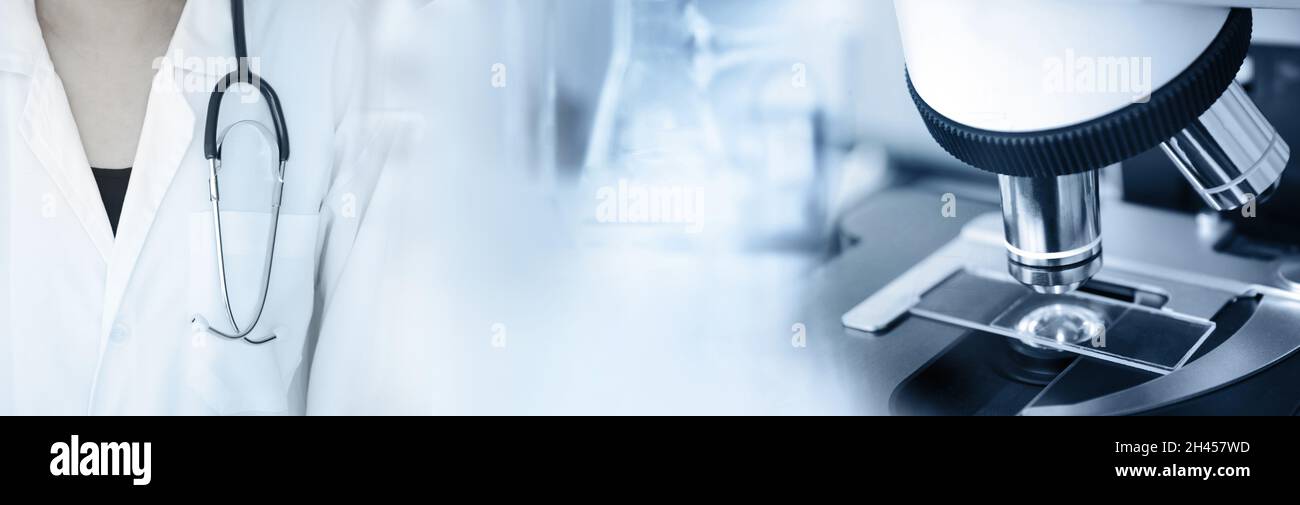 woman doctor in white coat with microscope in medical laboratory ...