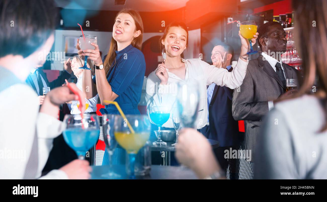 Young attractive women with cocktails having fun with workmate Stock ...