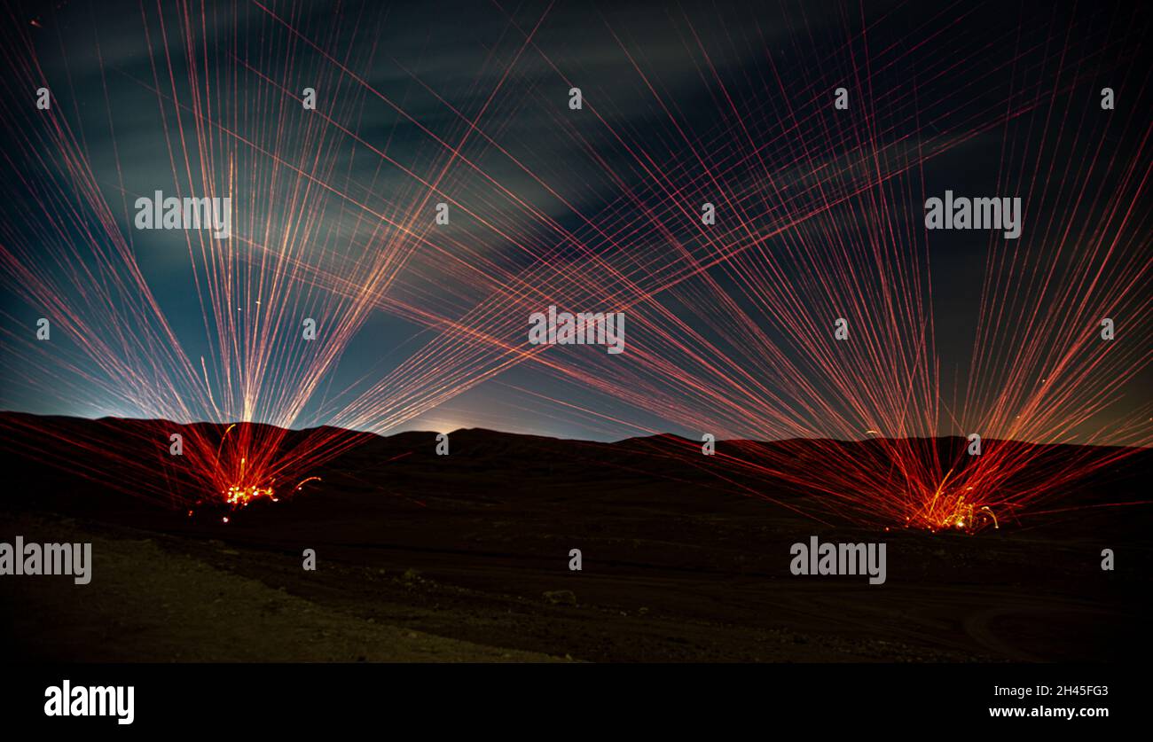 Rounds from a Dillon Aero M134D Minigun mounted on a helicopter strike ...