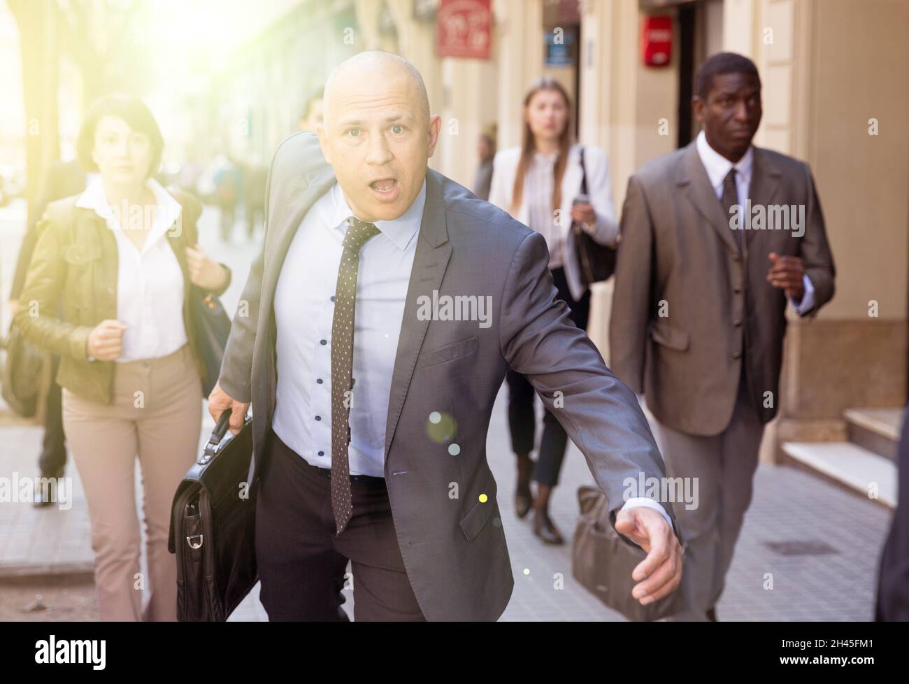 Hurrying into office building hi-res stock photography and images - Alamy