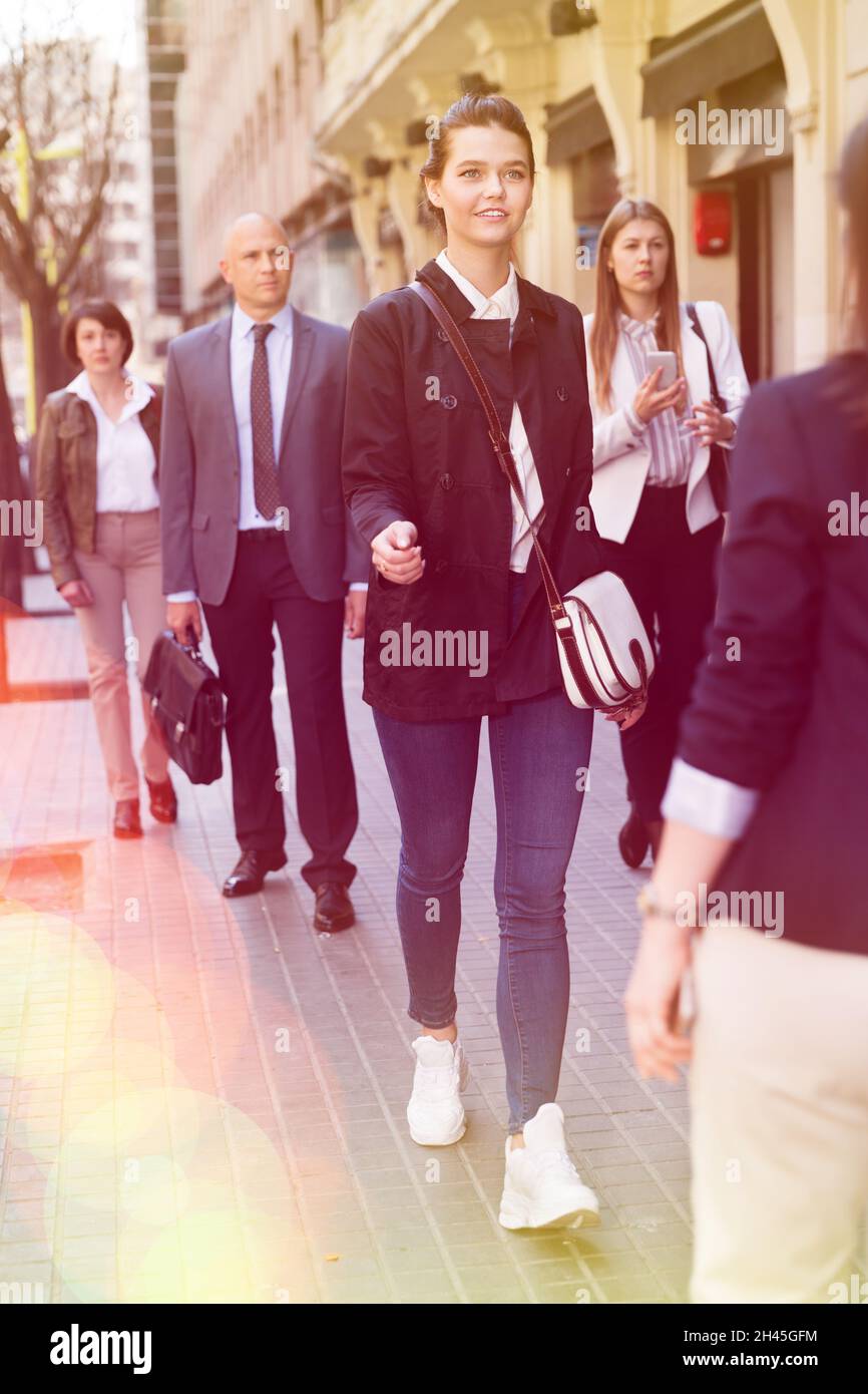 People in formal wear walking down street in city Stock Photo - Alamy