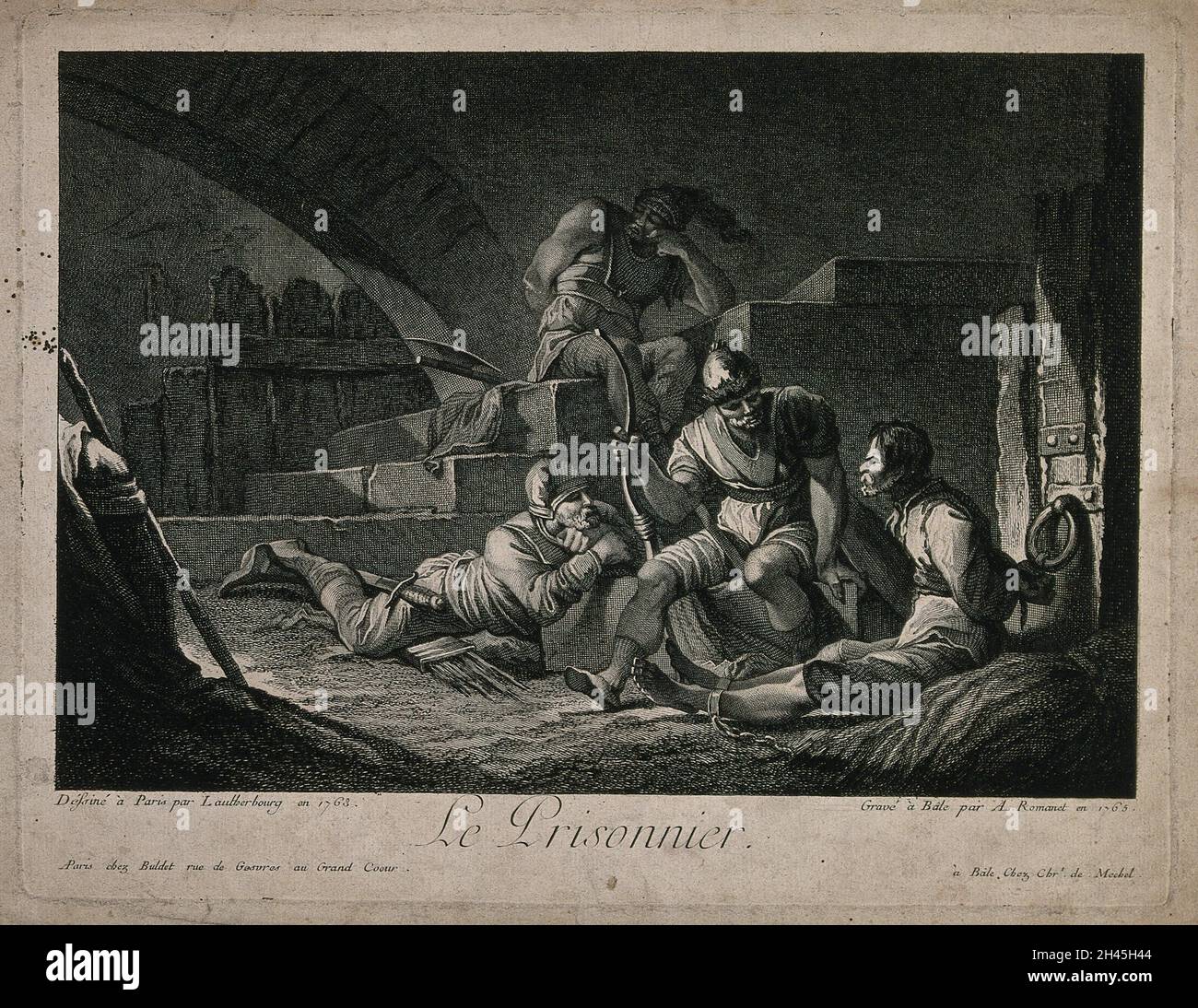 The guards in charge of a prisoner chained to the wall are talking to ...