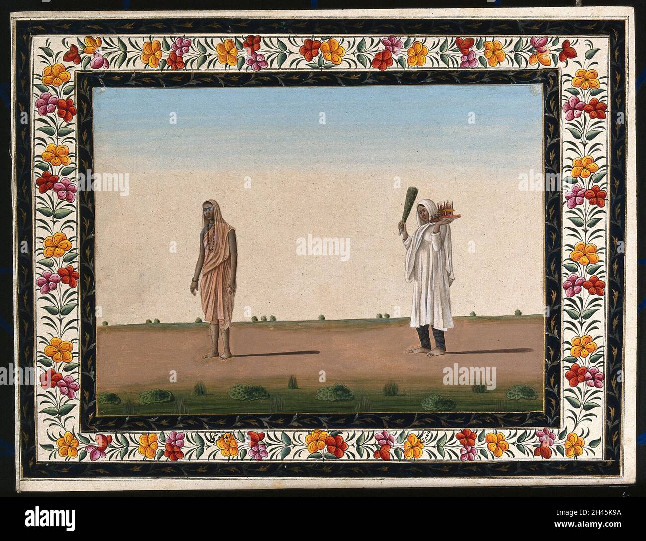 Two Indian women: (left) wearing pink robes and (right) holding a model ...