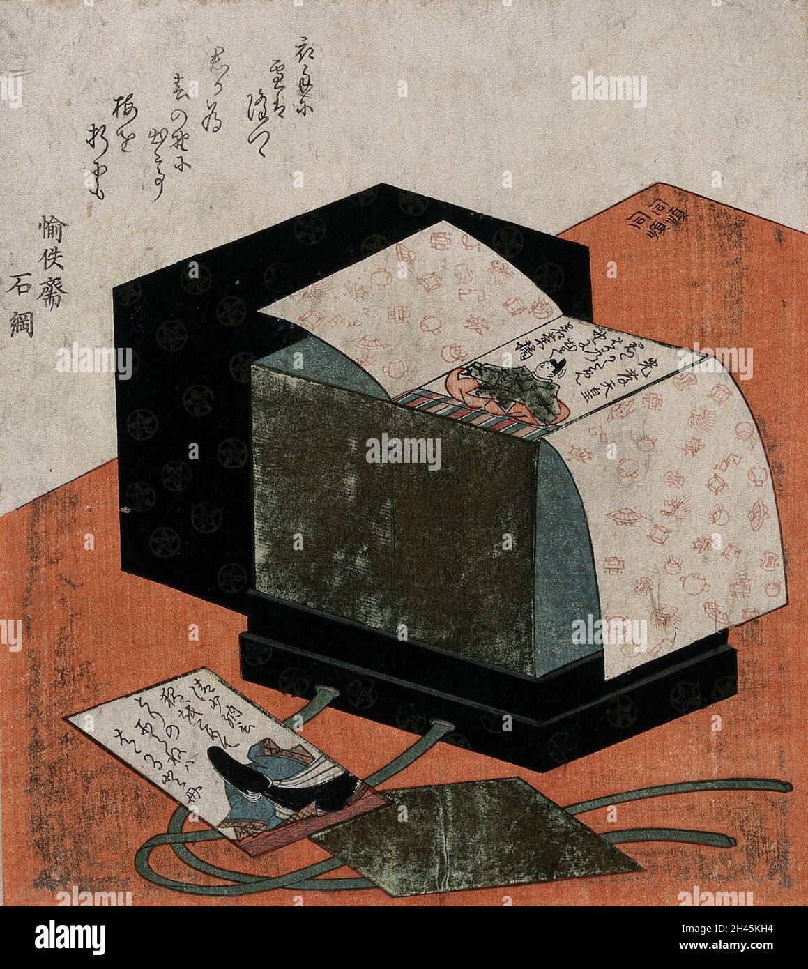 A lacquer box containing a set of poem cards, on a red table: the box ...