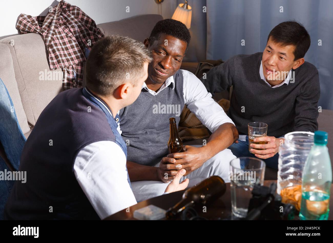 Three friends are talking about life together Stock Photo - Alamy