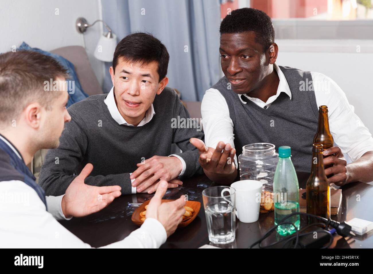 Three friends are talking about life together Stock Photo - Alamy