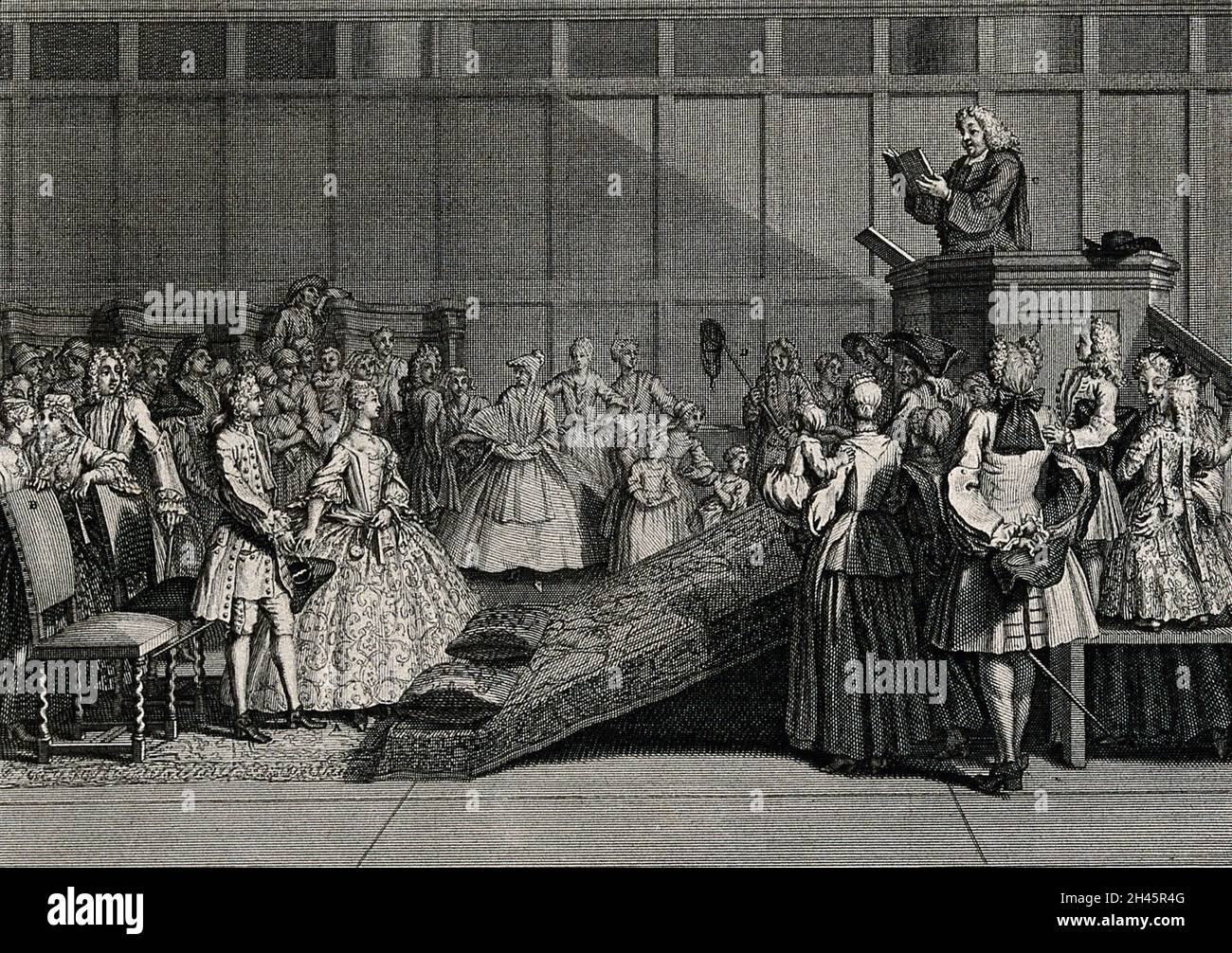 A marriage ceremony is performed with the priest in the pulpit and the ...