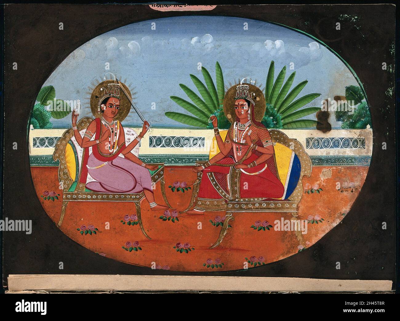 A three eyed Hindu deity with four arms sitting across a goddess with ...