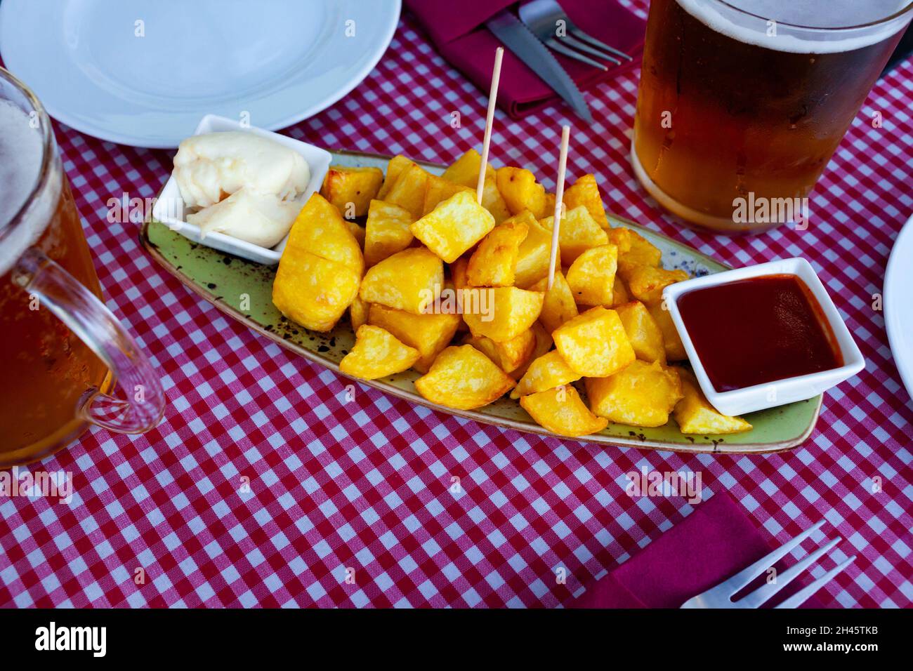 Spanish dish Patatas bravas with hot sauce Stock Photo - Alamy