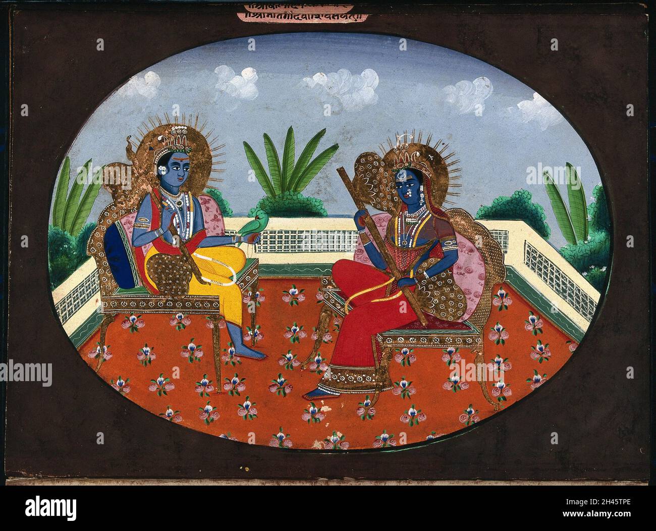 Two blue-skinned Hindu deities sitting across each other on golden ...