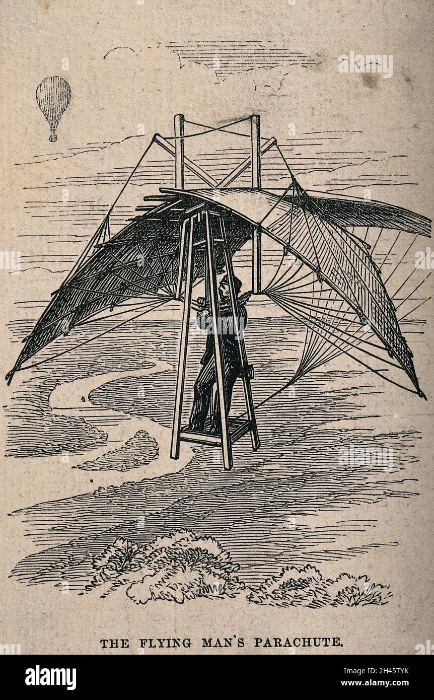 A man flying in a frame with wings attached and covering him; in the ...