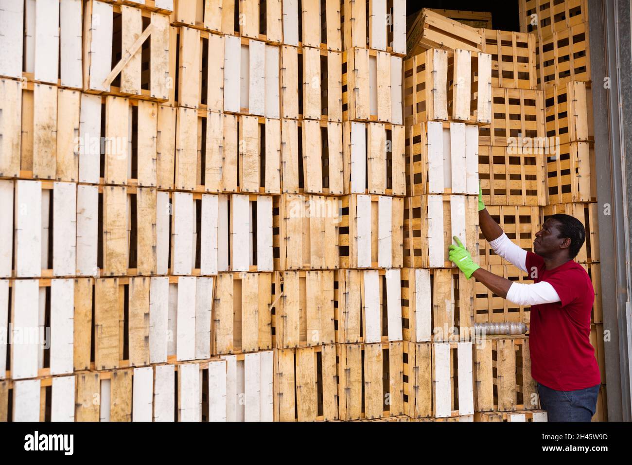 African american man stacking wooden crates Stock Photo - Alamy