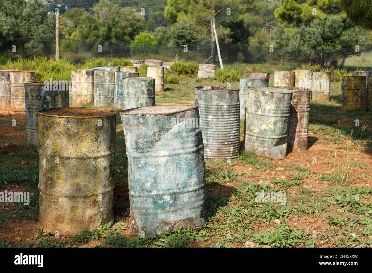 Paintball playground with barrels Stock Photo - Alamy