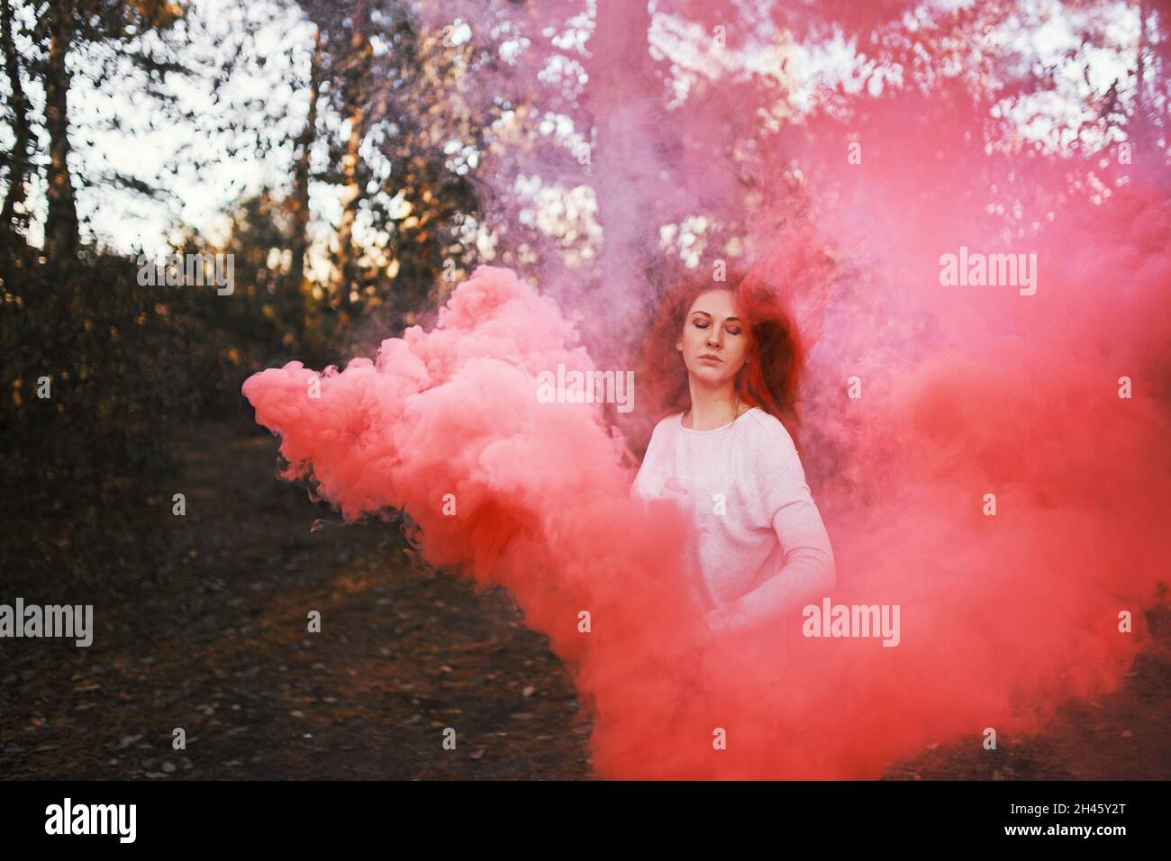 Smoke screen in the woods. Woman with smoke. Beautiful woman with pink ...