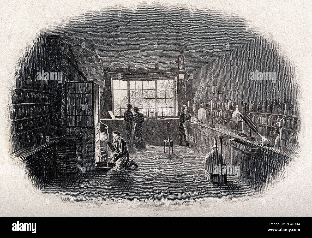 A chemical laboratory with four chemists; one looks into a furnace ...