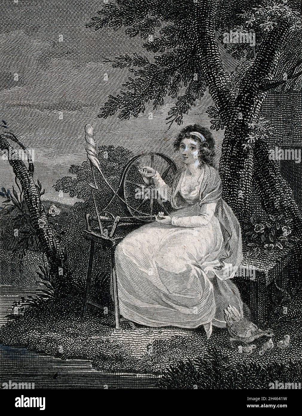 A young woman is using a spinning wheel under a tree with a spindle and ...