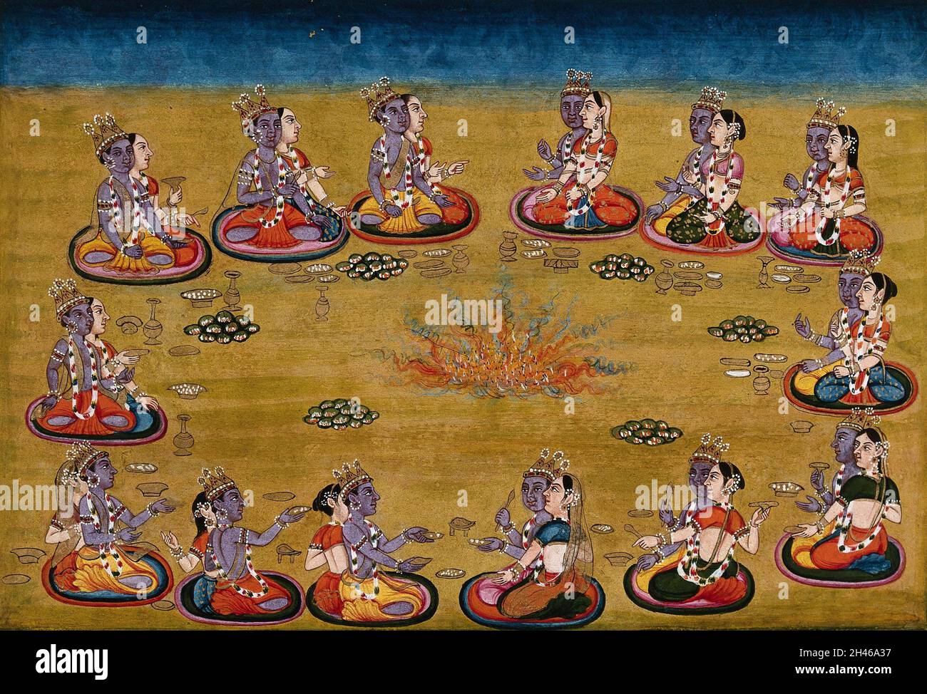 Fourteen couples with sacrificial vessels perform a yagna, a fire ...