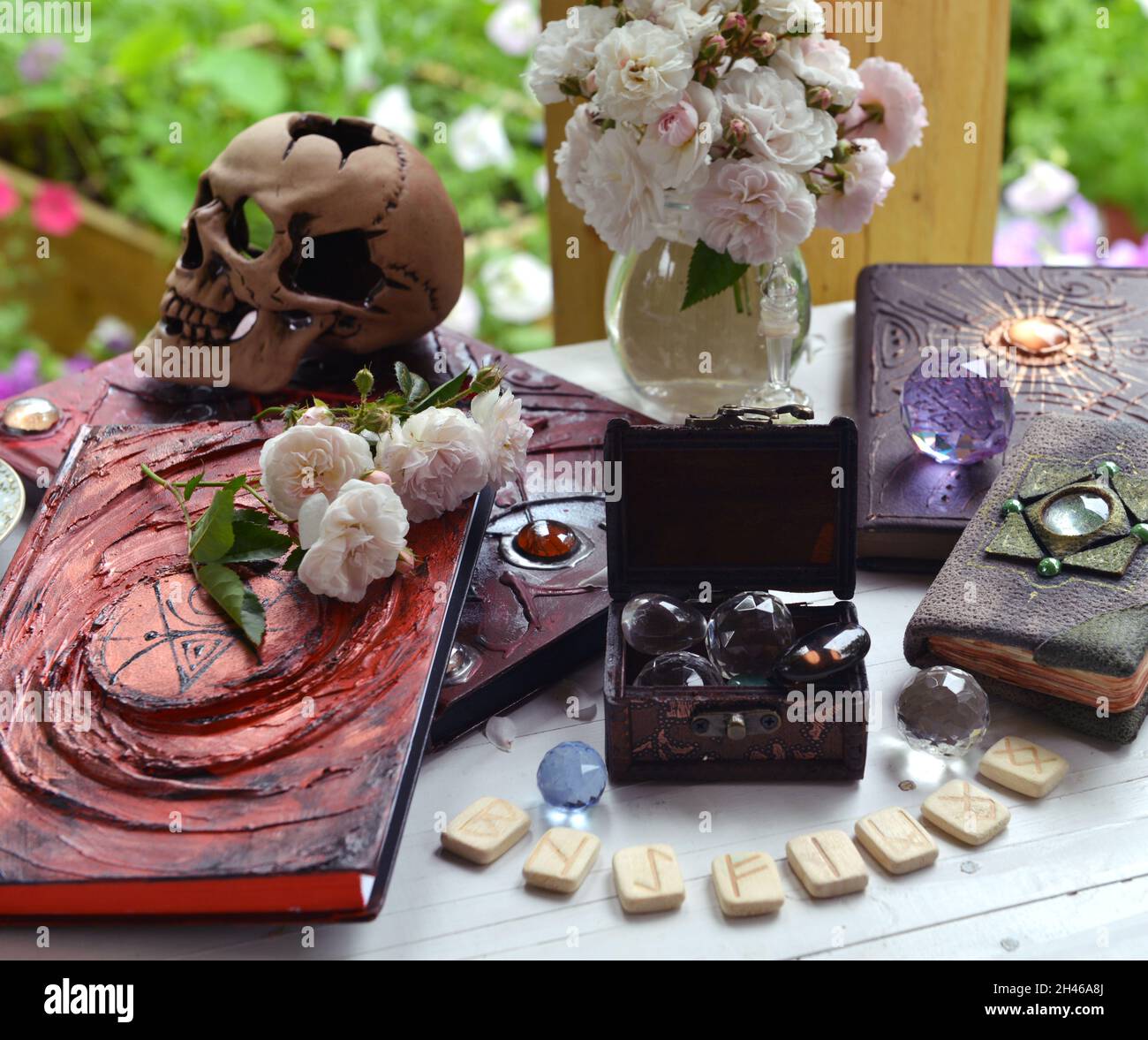 Vintage summer still life with runes, old book, skull and magic objects ...