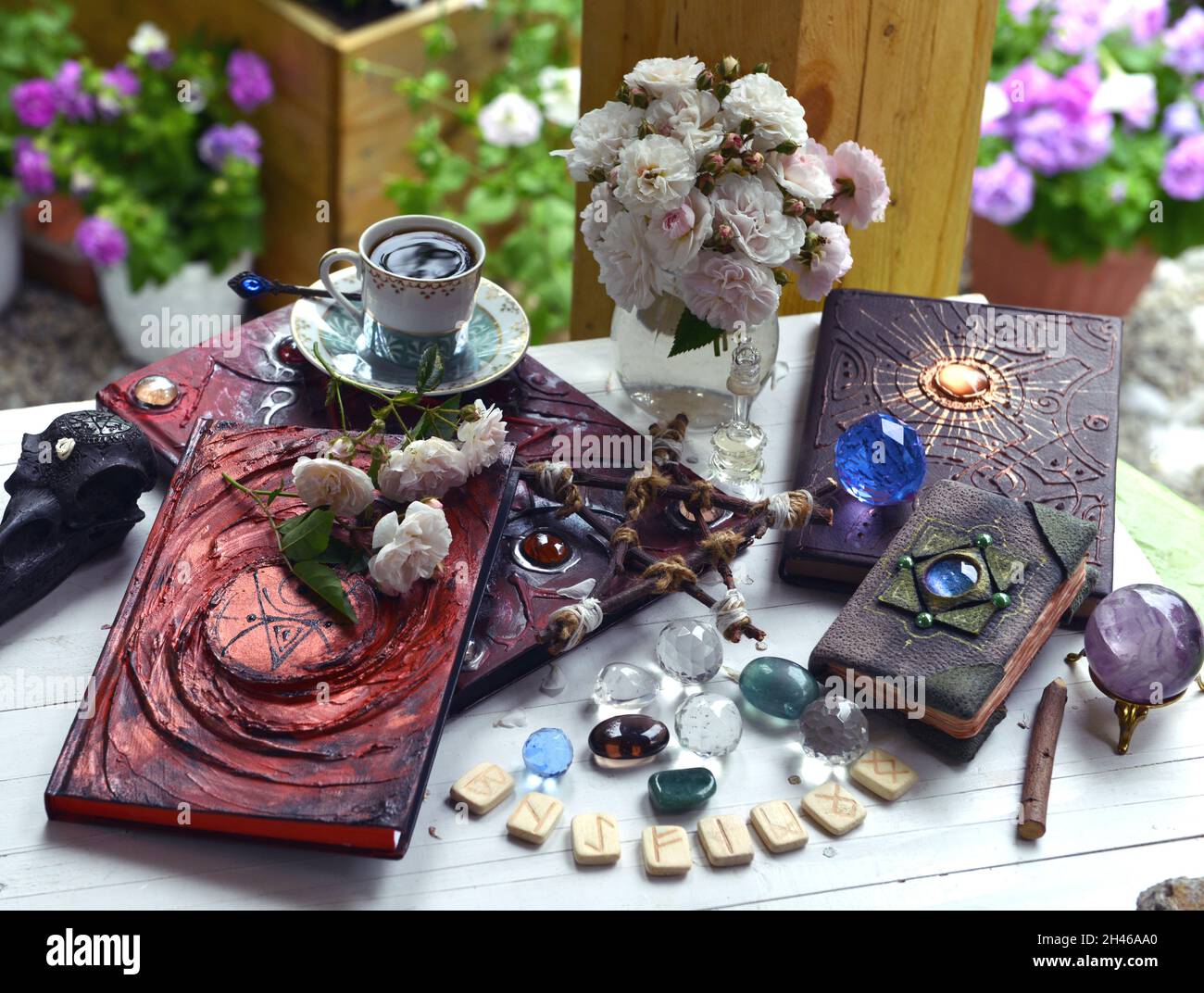 Vintage summer still life with old spell book, runes, crystals and ...