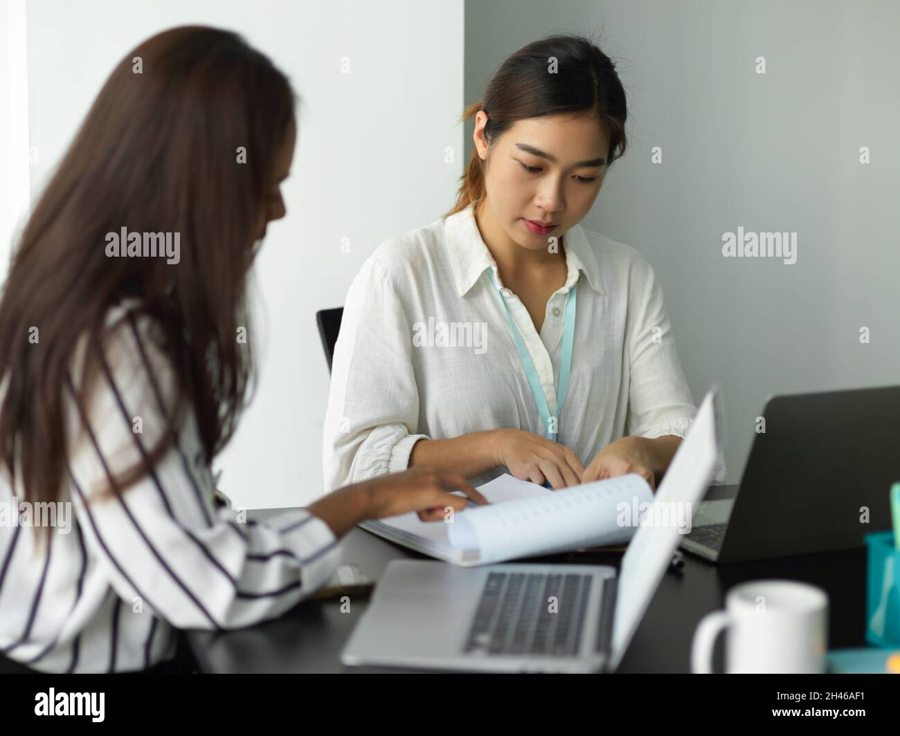 Concentrated woman works papers laptop hi-res stock photography and ...