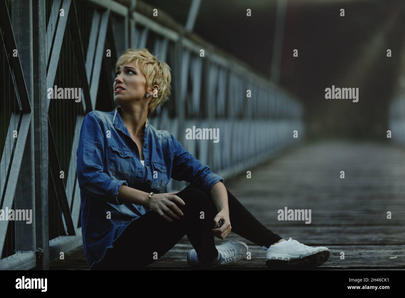 tourist sitting on the bridge worried about bad weather or something ...