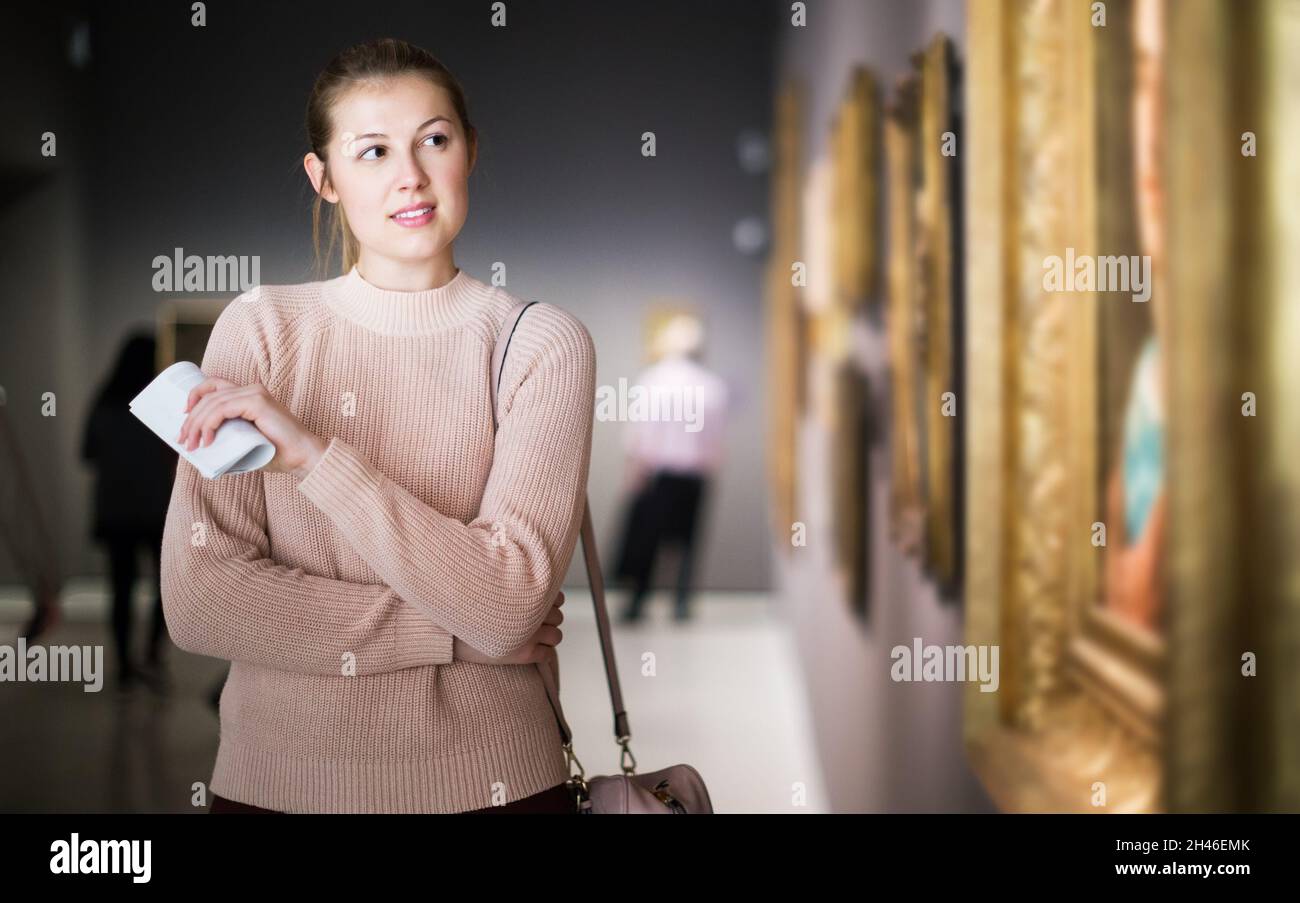 Woman at exhibition in museum Stock Photo - Alamy