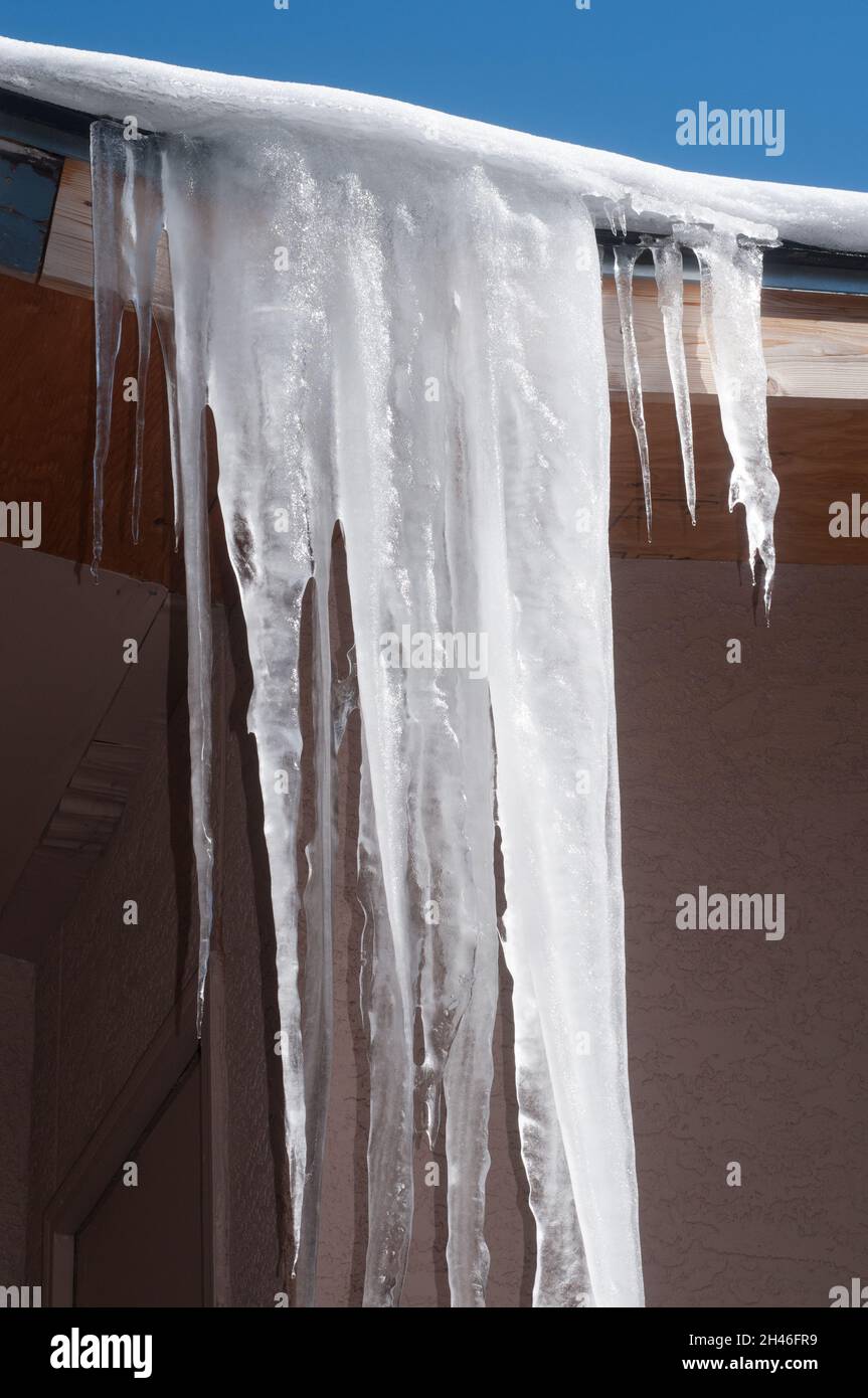 Ice hanging from a roof Stock Photo - Alamy