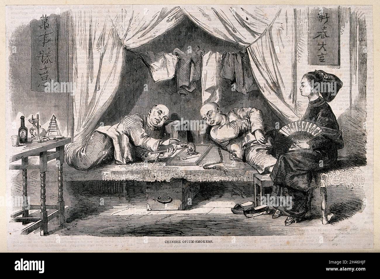 Two Chinese opium smokers reclining in a booth watched by a woman with ...