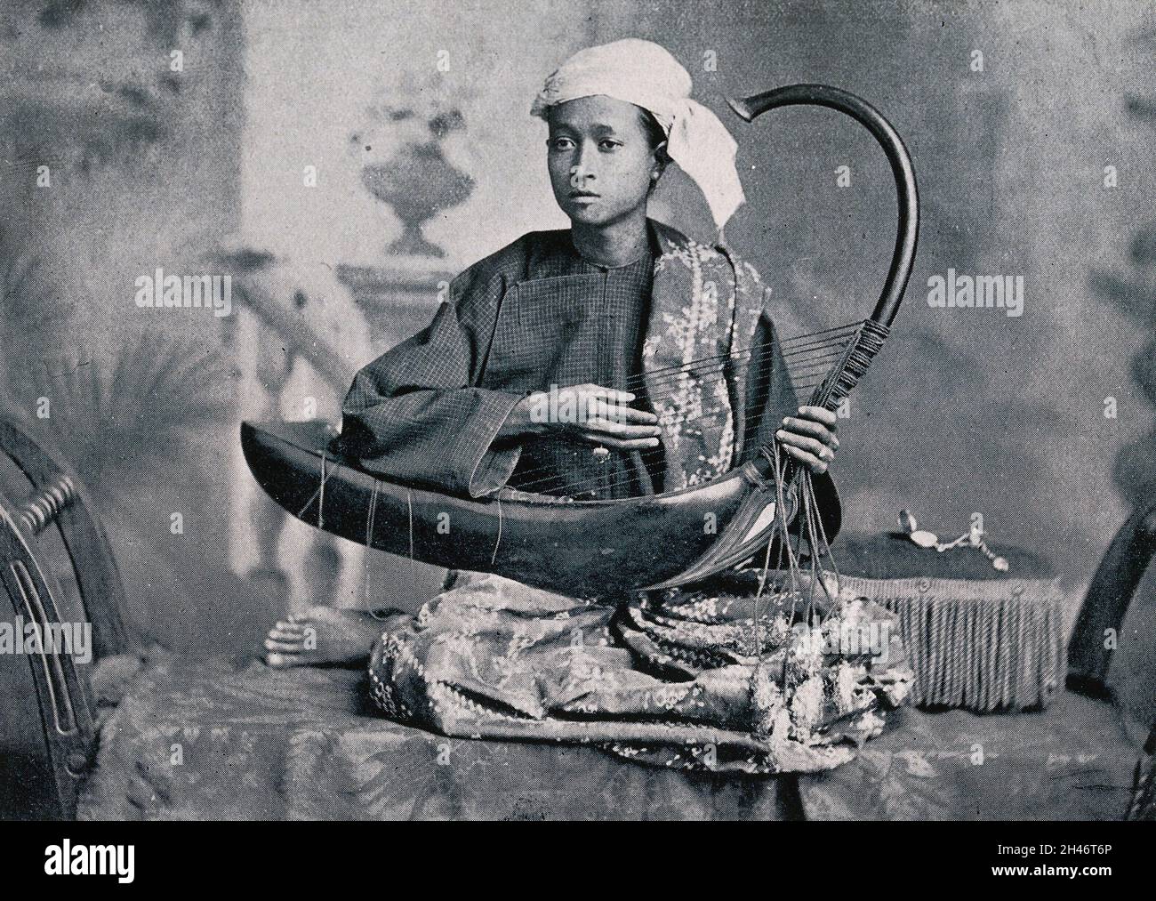 A boy playing a saung or Burmese harp. Process print Stock Photo - Alamy