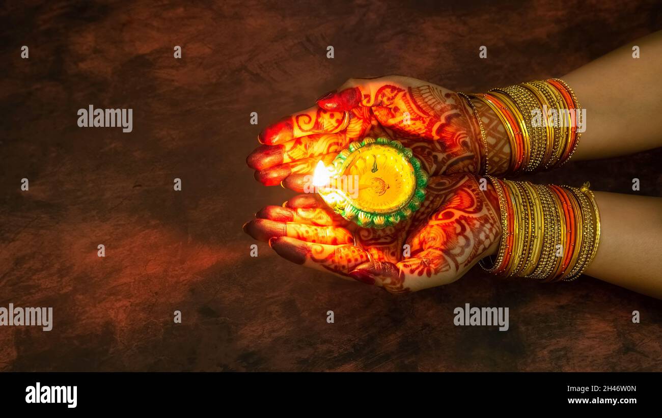Diya in hand hi-res stock photography and images - Alamy