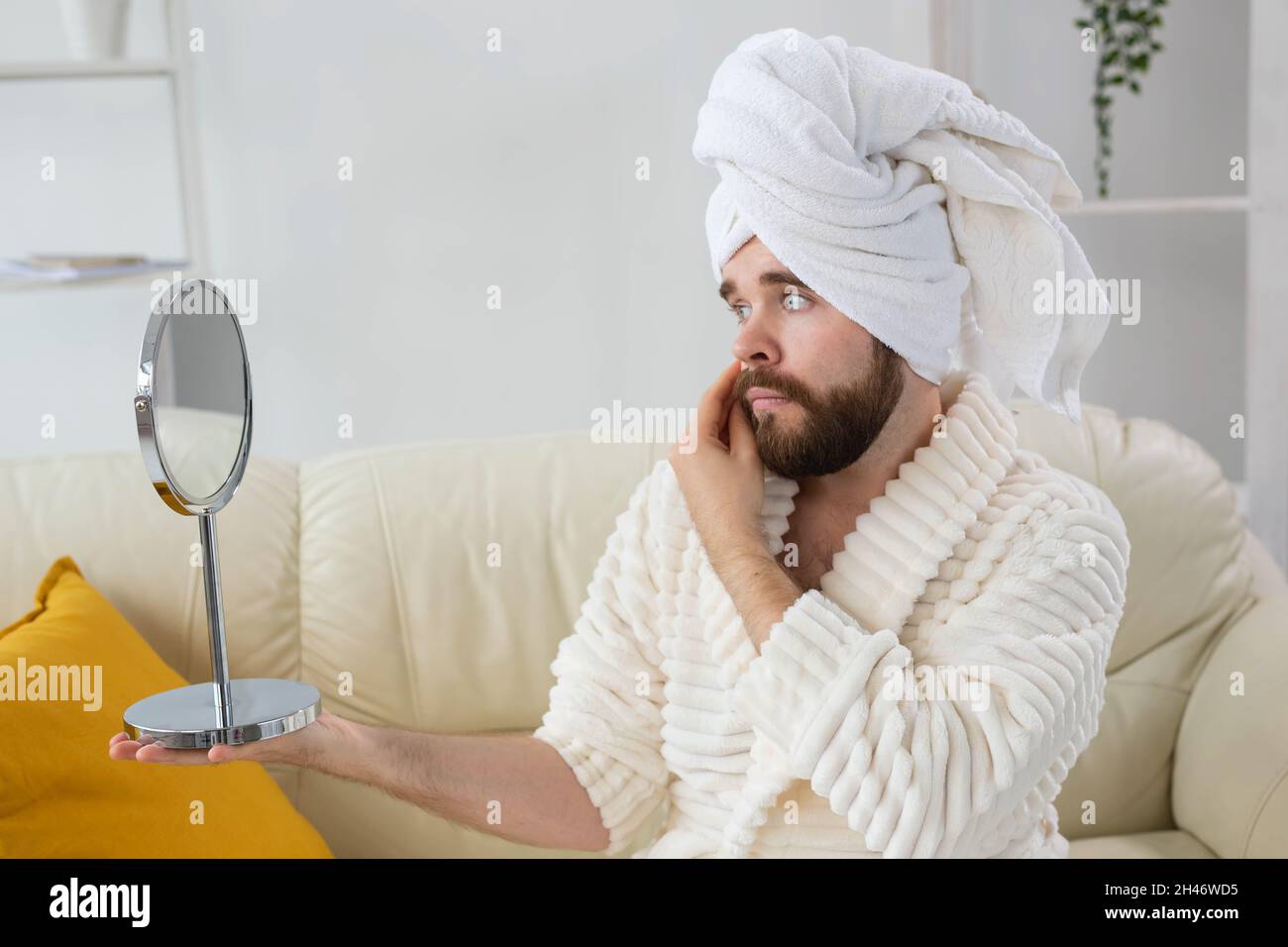 Handsome man cleaning face skin with cotton pads. Spa, body and skin ...