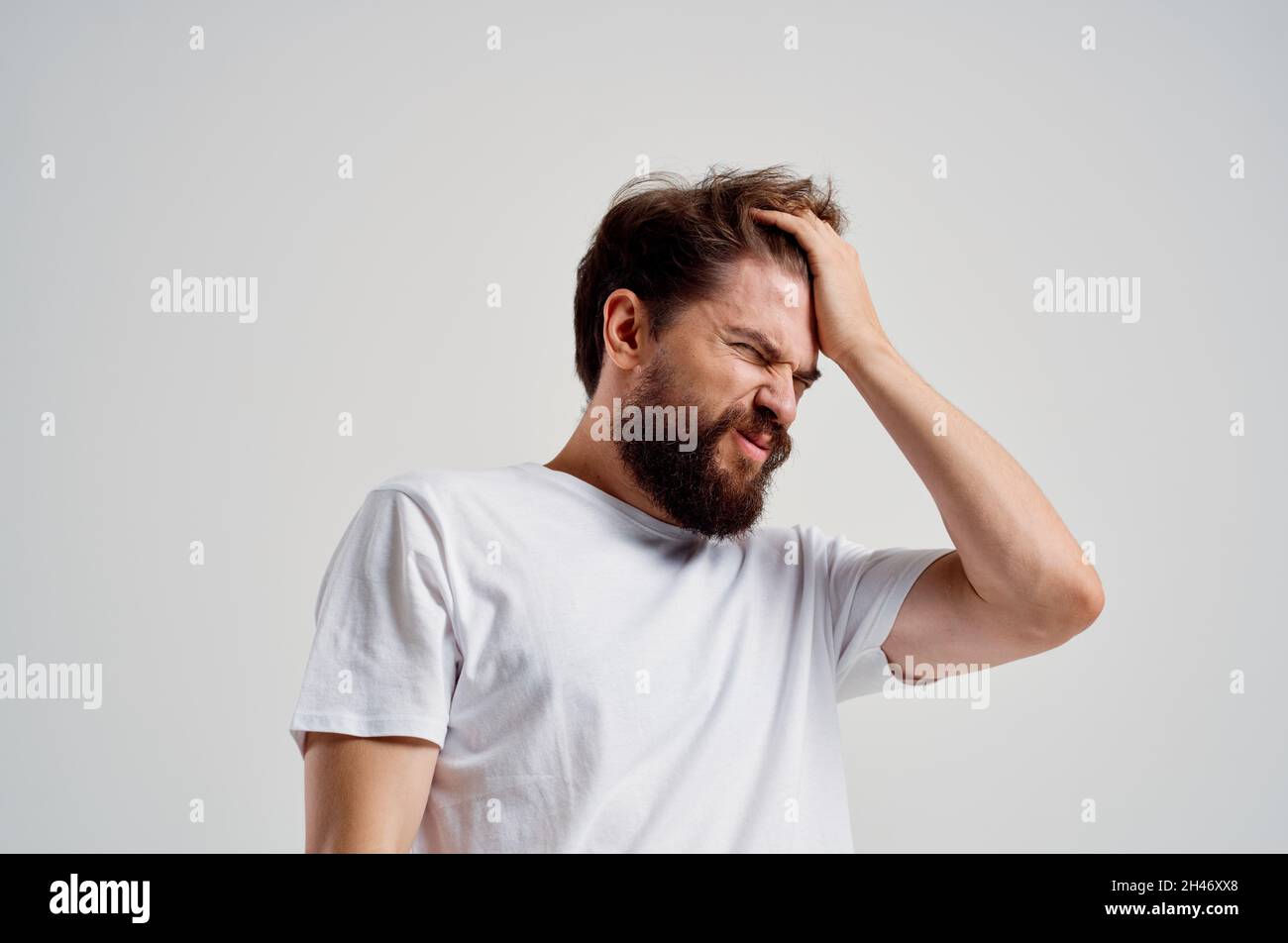 man holding his head pain stress emotions isolated background Stock ...