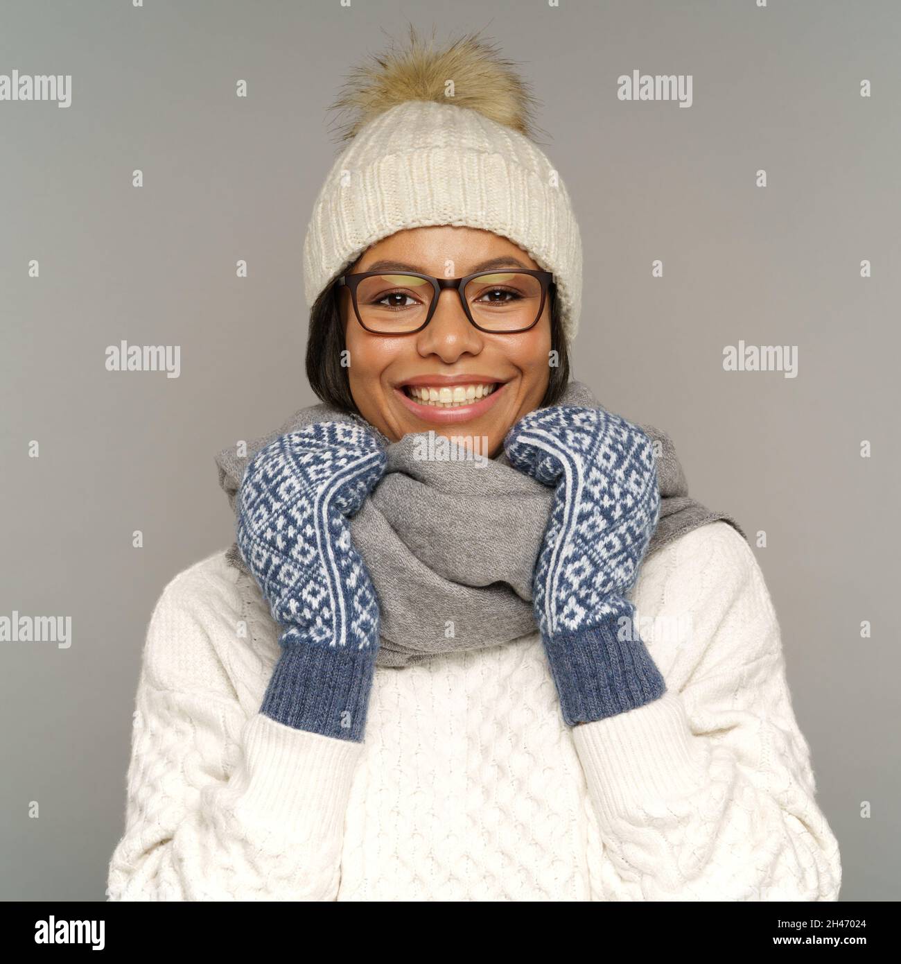 Warm winter clothes: happy smiling black woman wearing knitted white ...