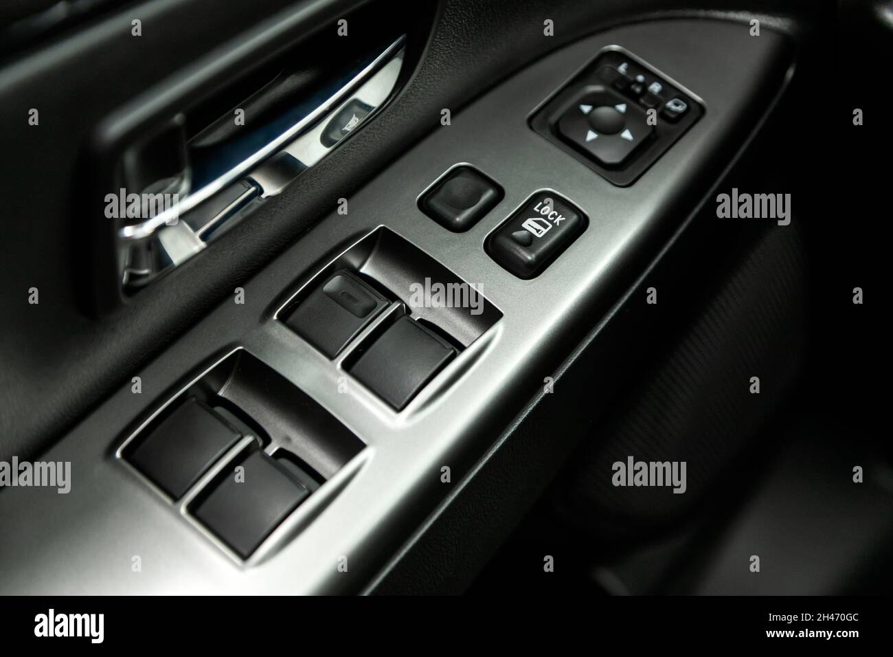 Arm rest with window control panel, door lock button, and mirror ...