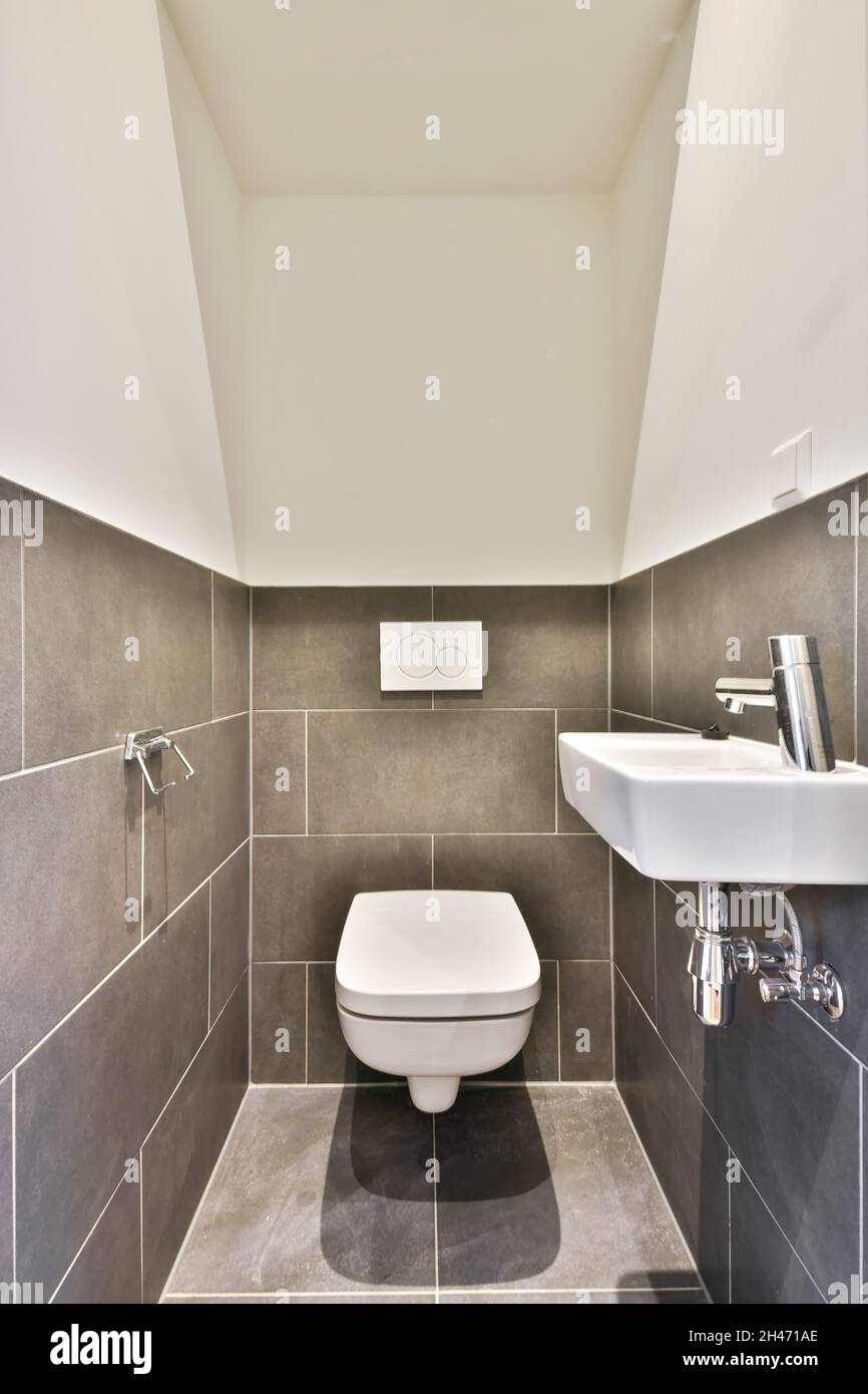 Interior of small clean restroom in miniature style Stock Photo - Alamy