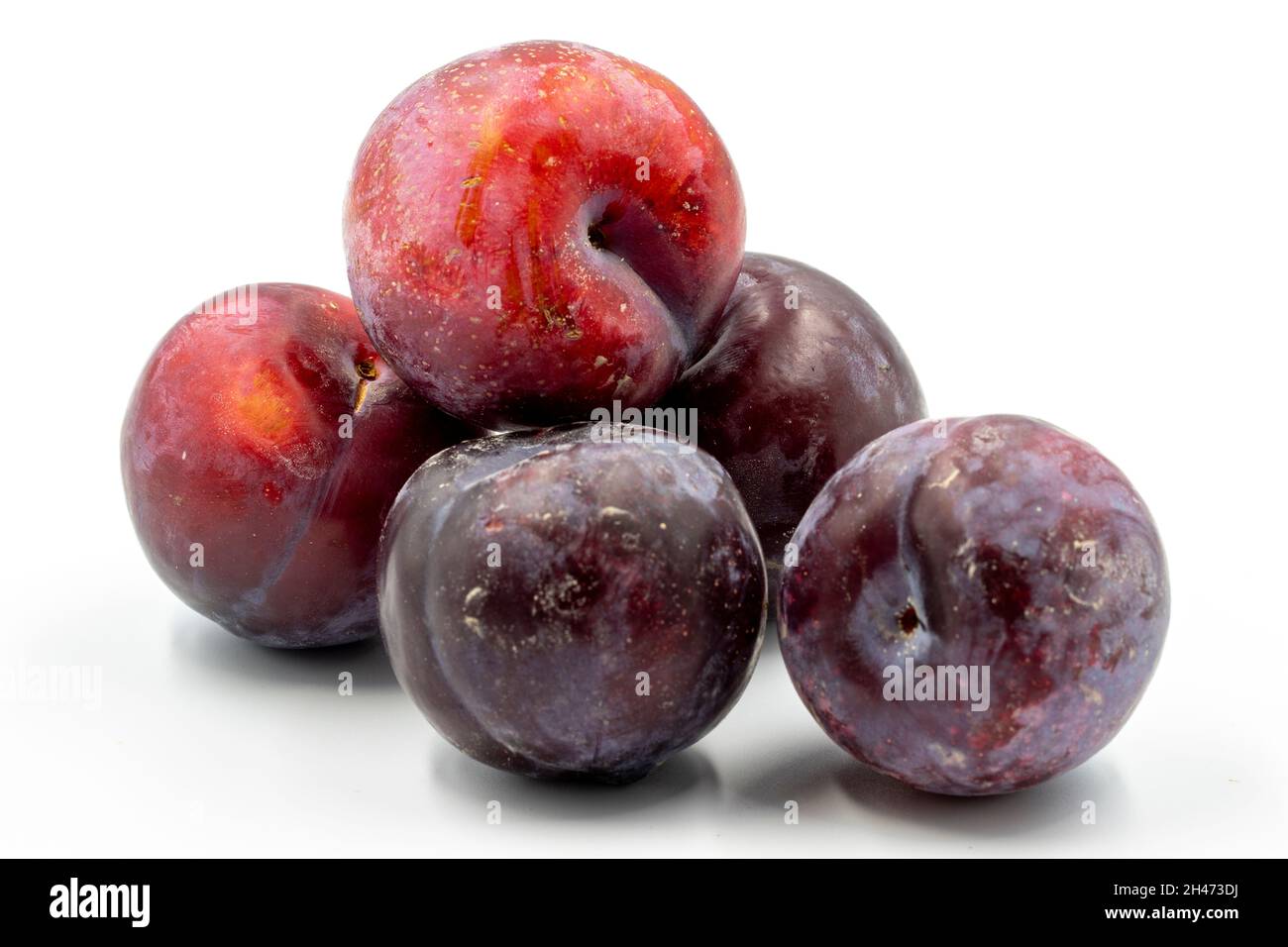 Black plum on a white background. Combined with a mature black plum ...