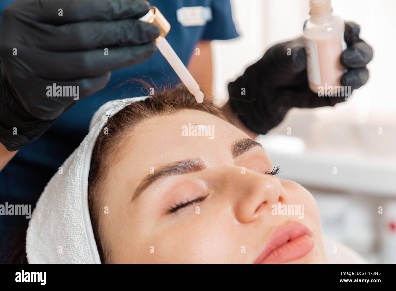Young womans hands apply serum hi-res stock photography and images - Alamy