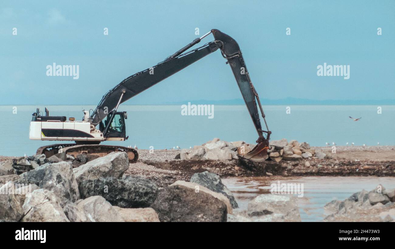 Digger working at landfill site Stock Photo - Alamy