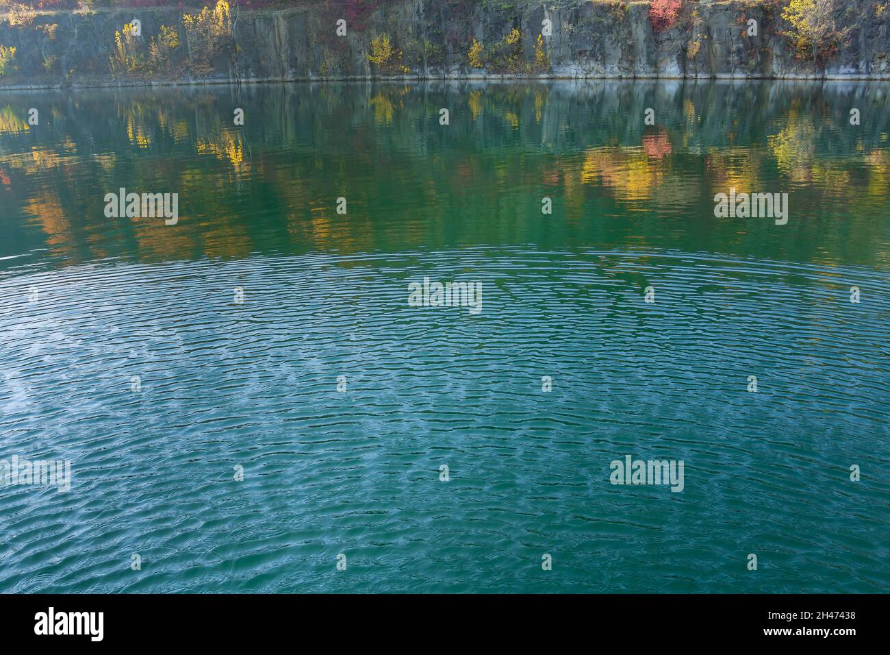 Artificial pond with azure water and picturesque flooded quarries Stock ...