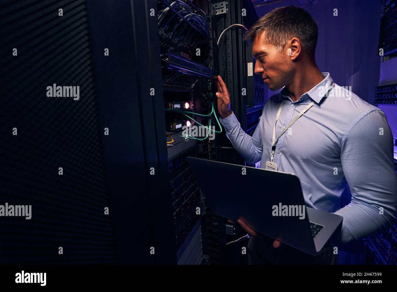 Experienced data center system administrator running equipment diagnostics Stock Photo - Alamy