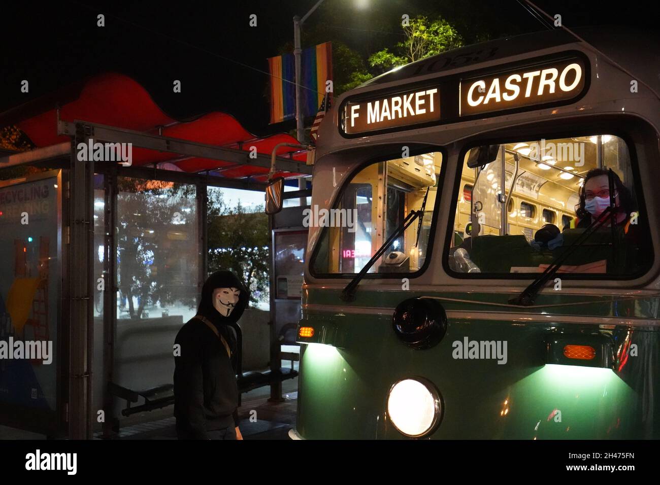 A person wearing a mask walks along Castro street during the Halloween ...