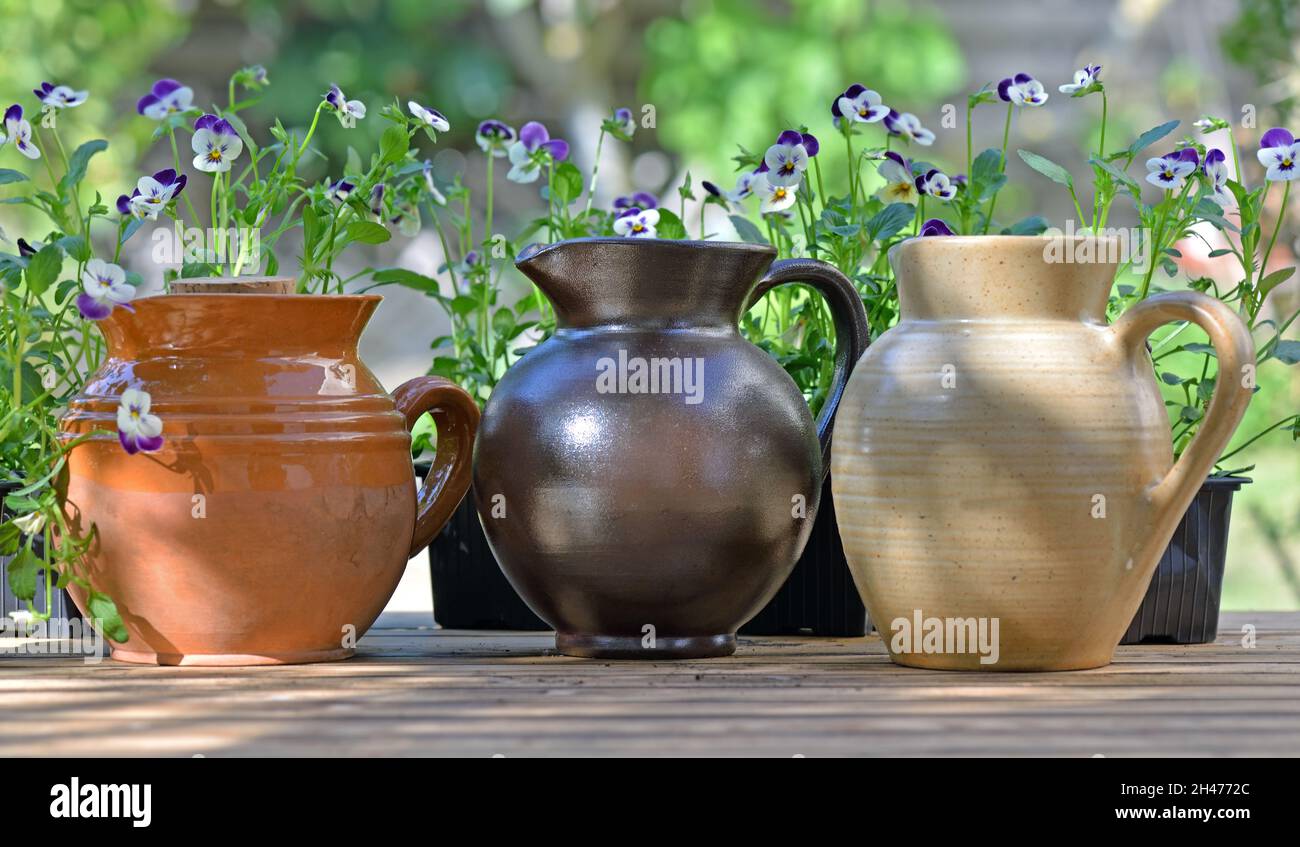 decorative pottery placed on a table with flowers in garden Stock Photo ...