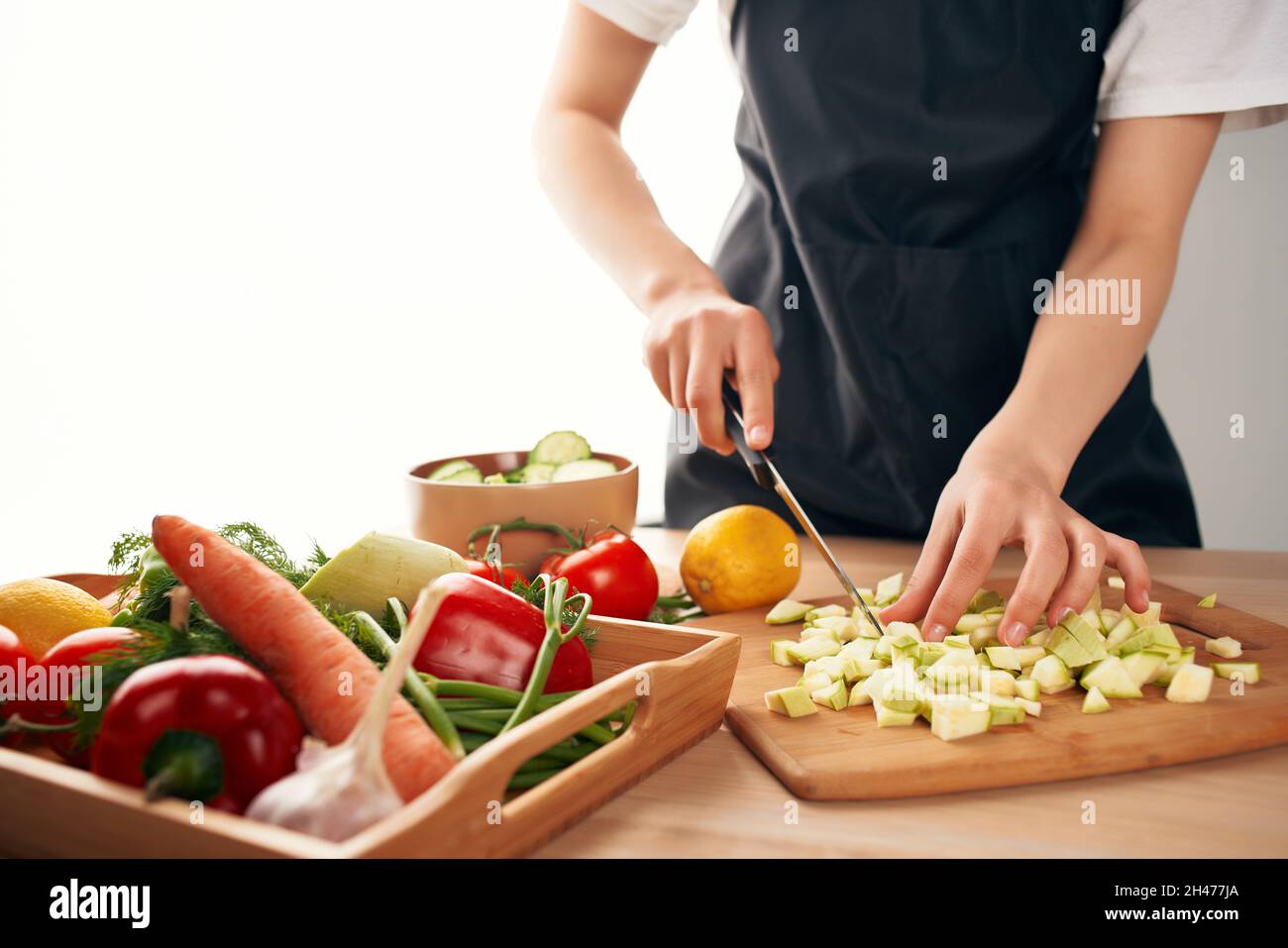 Woman slicing fresh cucumber in hi-res stock photography and images - Alamy