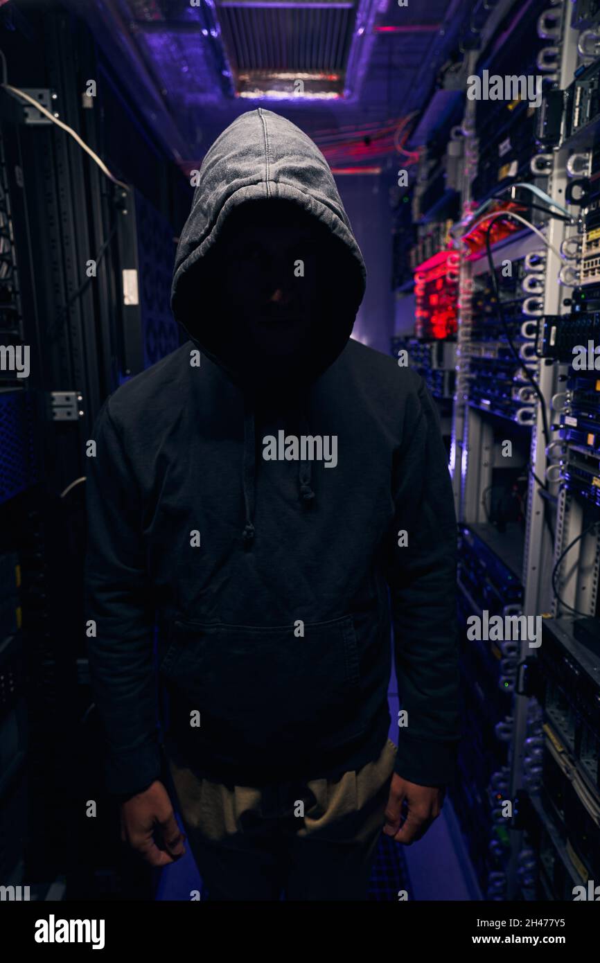 Data center intruder among racks with computer equipment Stock Photo ...