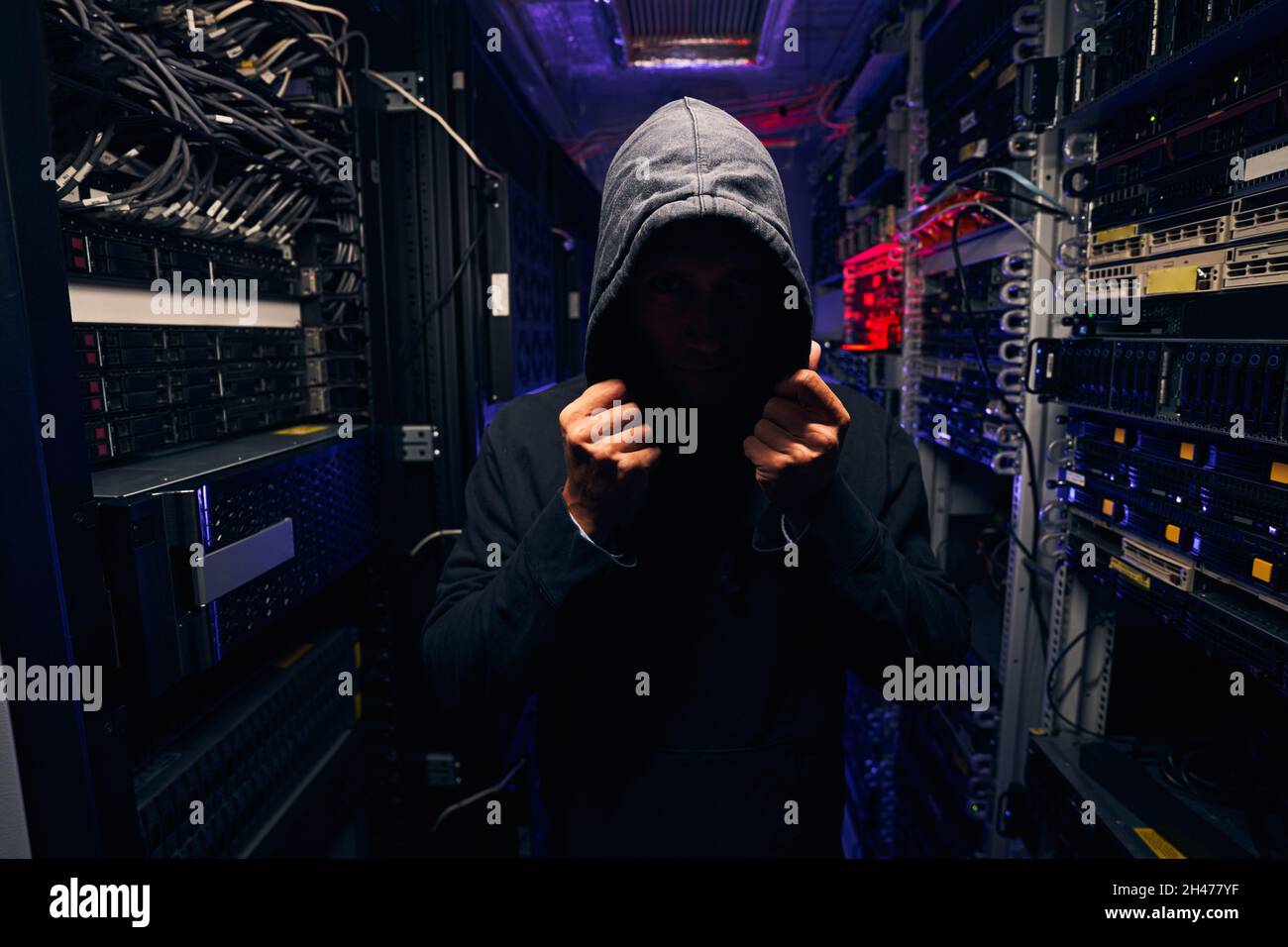 Data center intruder trying to cover his face Stock Photo - Alamy