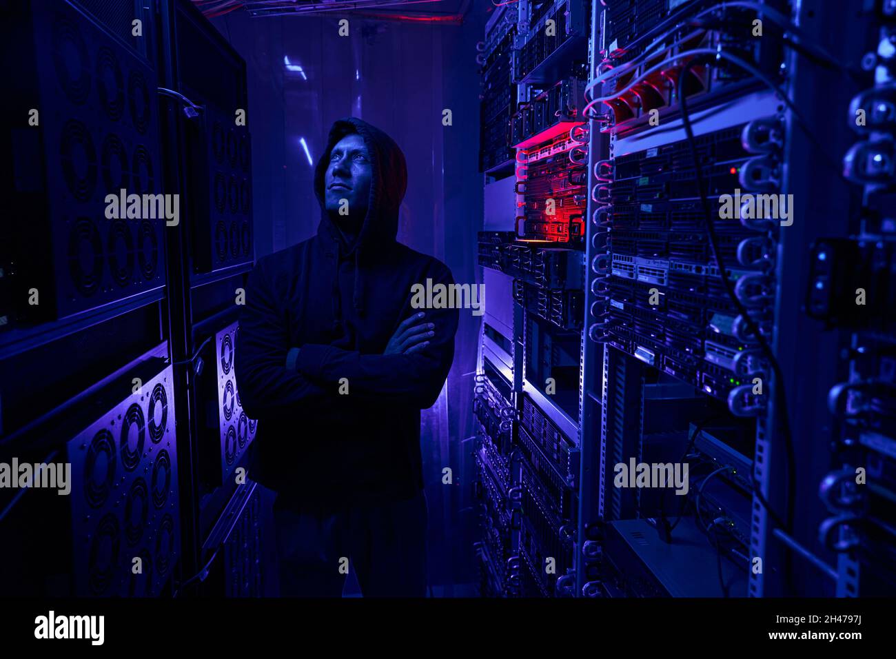 Serious data center intruder examining network equipment Stock Photo ...