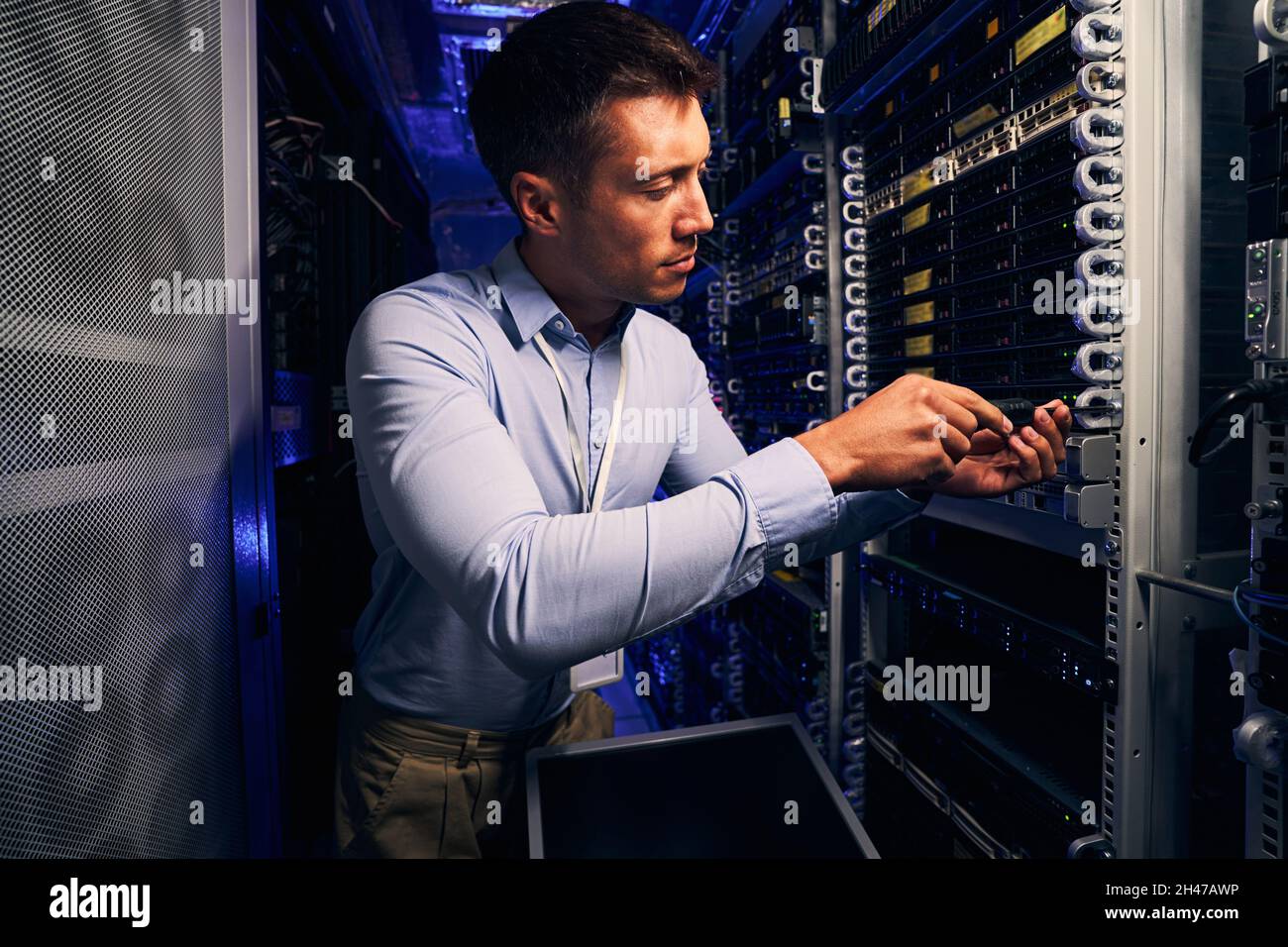 Professional engineer installing equipment in data center Stock Photo - Alamy