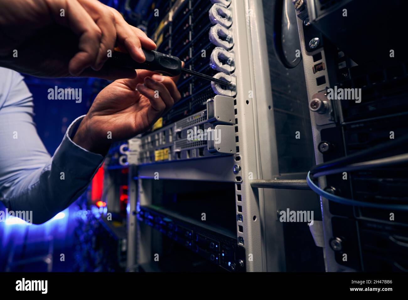 Engineer installing network equipment in data center Stock Photo - Alamy