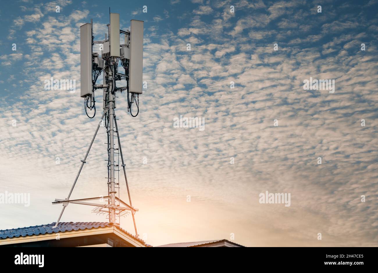 Telecommunication tower with blue sky and white clouds background ...